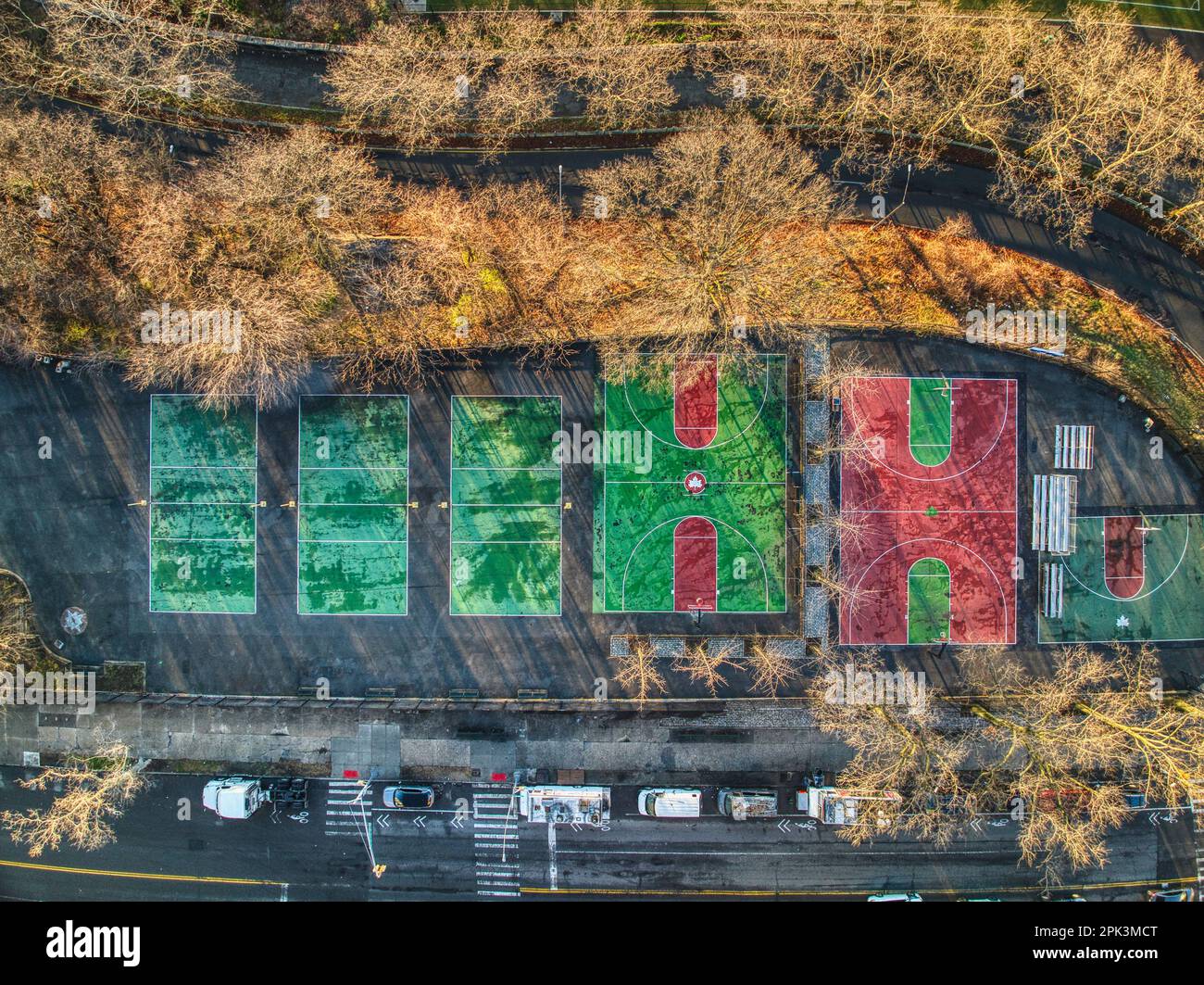 An aerial view of a vibrant and colorful tennis court surrounded by ...