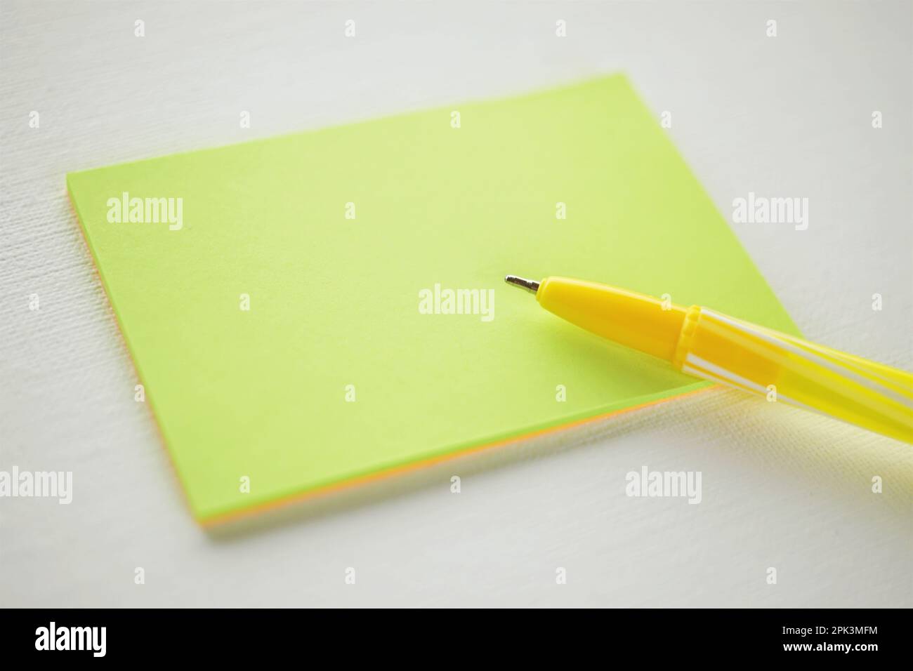 Yellow ballpoint pen and green notes close-up on white paper Stock ...