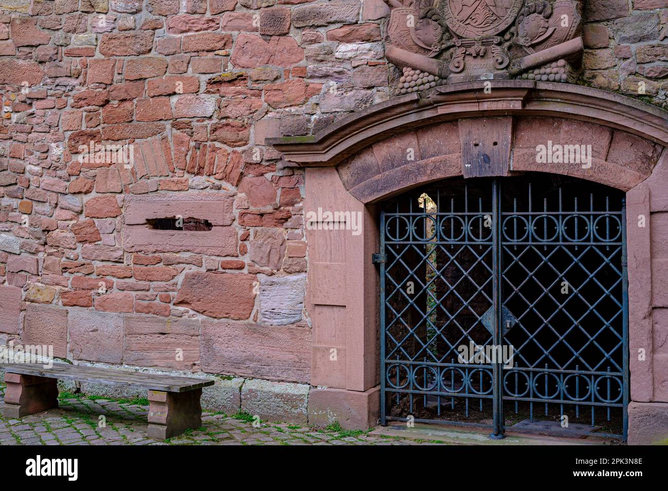 Historic iron grate in a wall opening at Burgweg lane leading up to ...