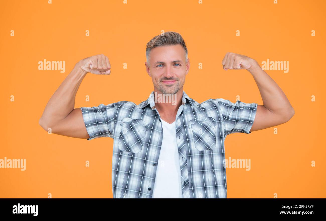 strong mature man with grizzle hair on yellow background Stock Photo ...