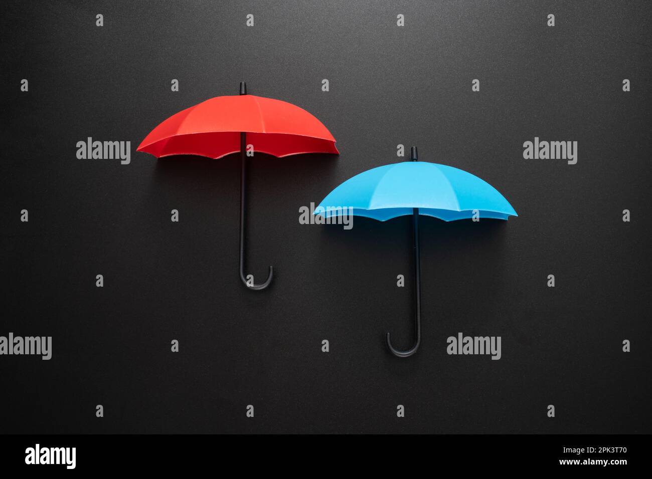 Red and blue umbrellas isolated on black background Stock Photo - Alamy