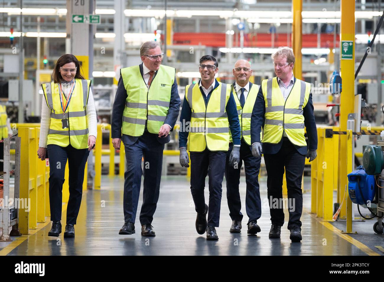 Prime Minister Rishi Sunak (centre) meets staff during a visit to the ...
