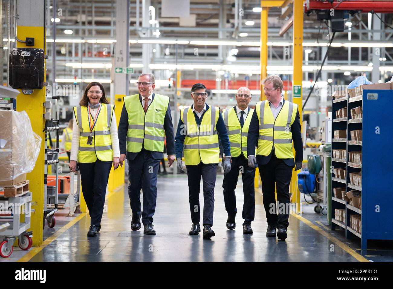 Prime Minister Rishi Sunak (centre) meets staff during a visit to the ...