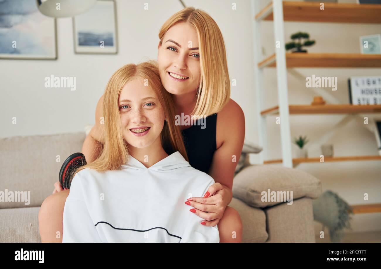 Positive emotions. Female teenager with her mother is at home at ...