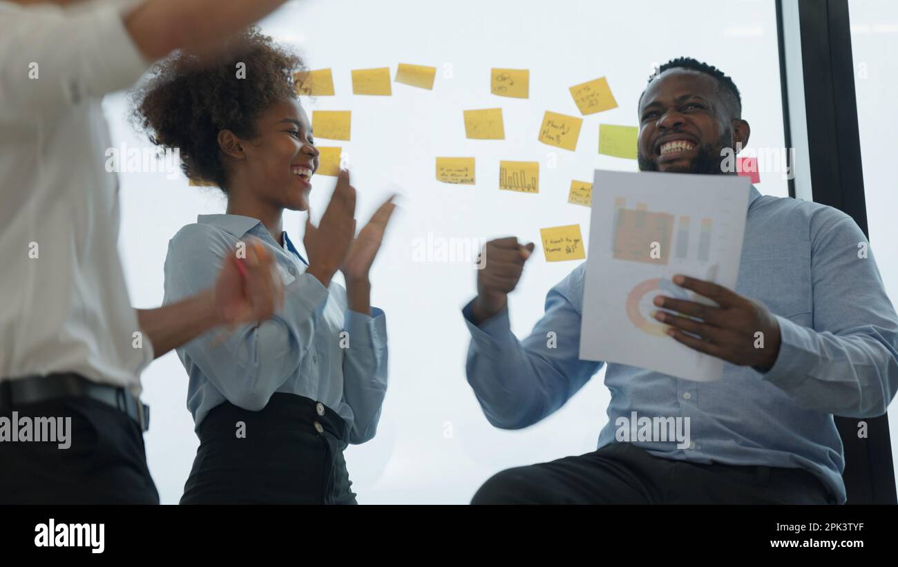 Happy colleagues celebrating success hi-res stock photography and ...