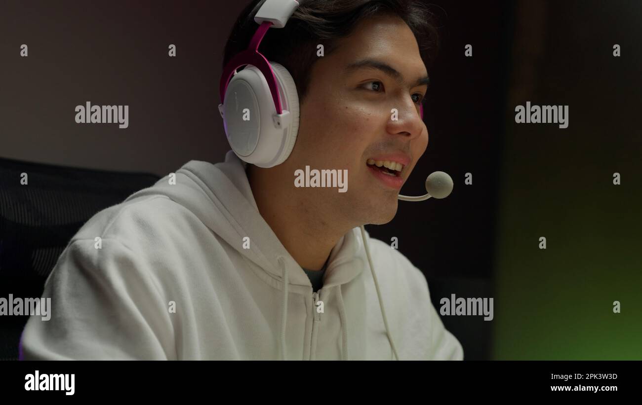 Game streamer using pc setup playing multiplayer first person shooter ...