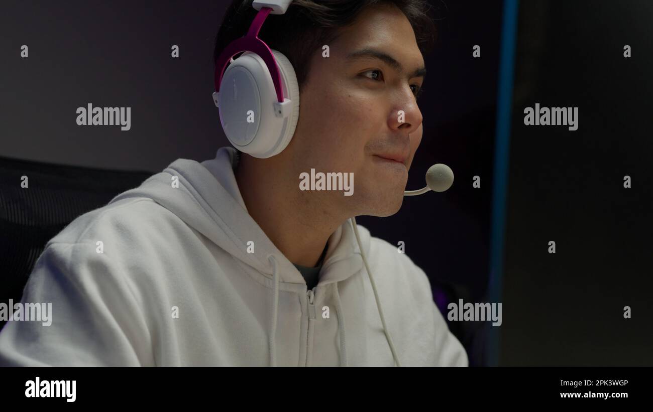 Game streamer using pc setup playing multiplayer first person shooter ...