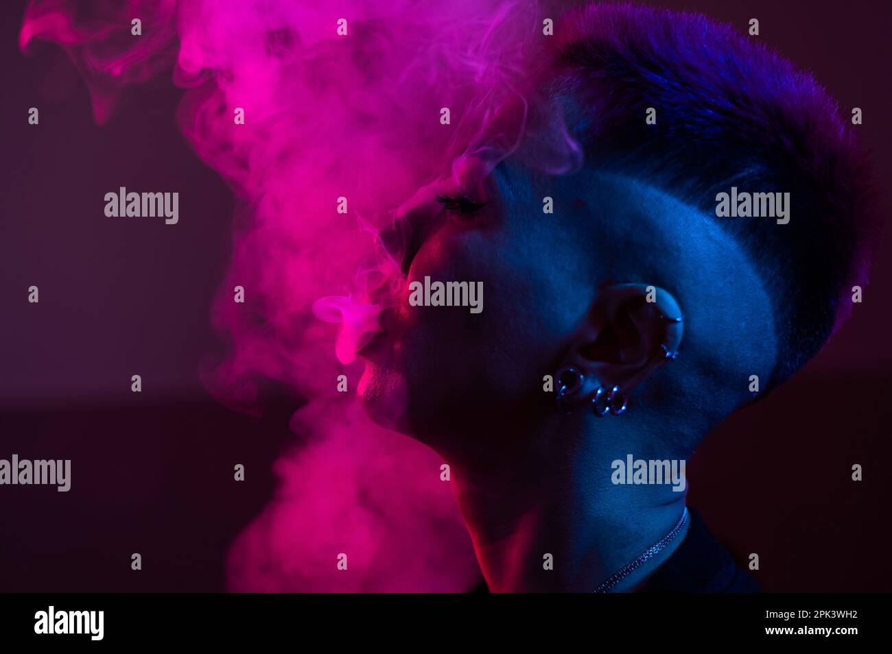 Profile Asian woman with short haircut smoking in neon light Stock ...
