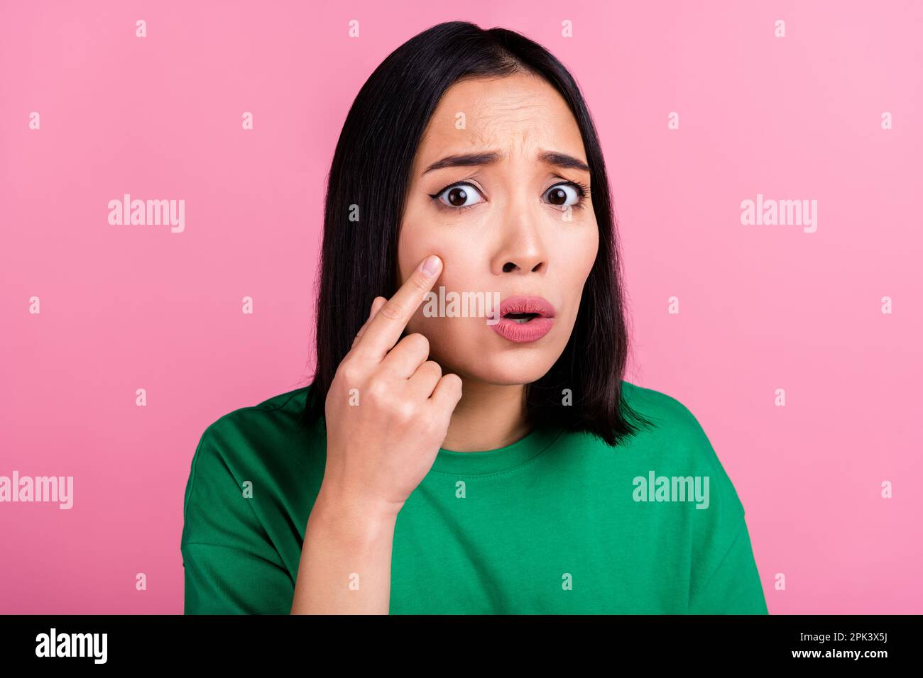 Portrait of impressed negative lady finger touch cheek pimple wrinkle ...