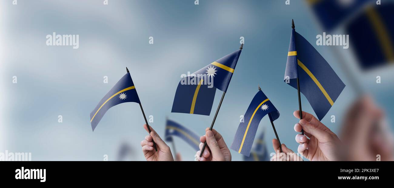 A group of people holding small flags of the Nauru in their hands Stock ...