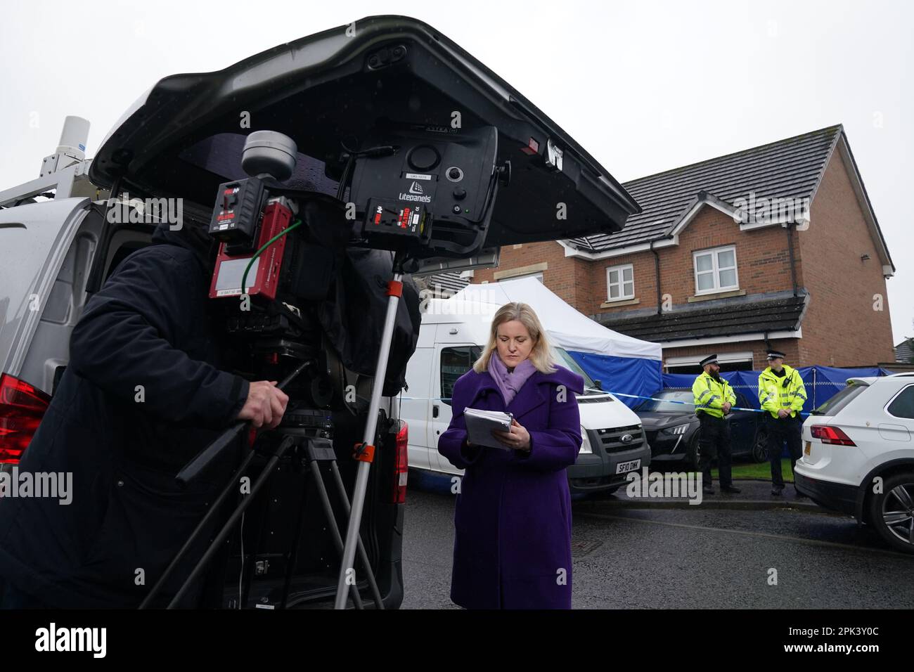 A member of the media with officers from Police Scotland outside the ...