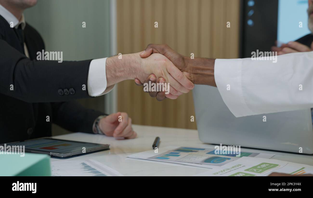 Businessmen shacking hands together showing successful contract ...