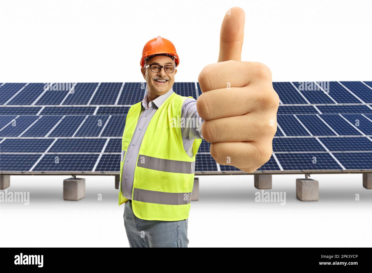 Cheerful mature male engineer showing thumbs up at a solar farm ...
