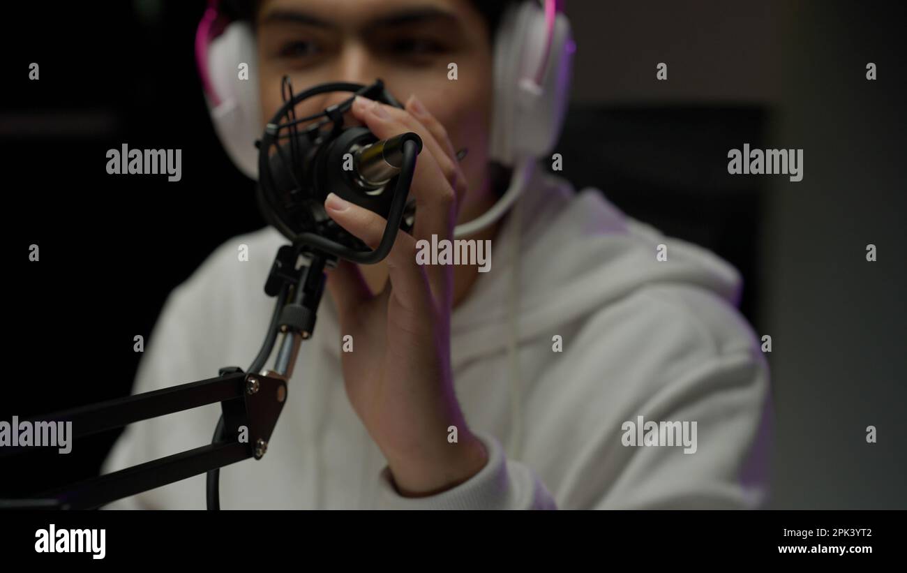Game streamer using pc setup playing multiplayer first person shooter ...