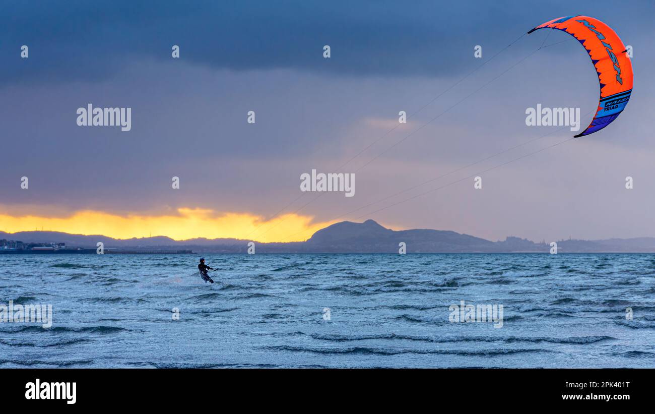 Kit Surfer Sunset with Edinburgh skyline in background Stock Photo - Alamy