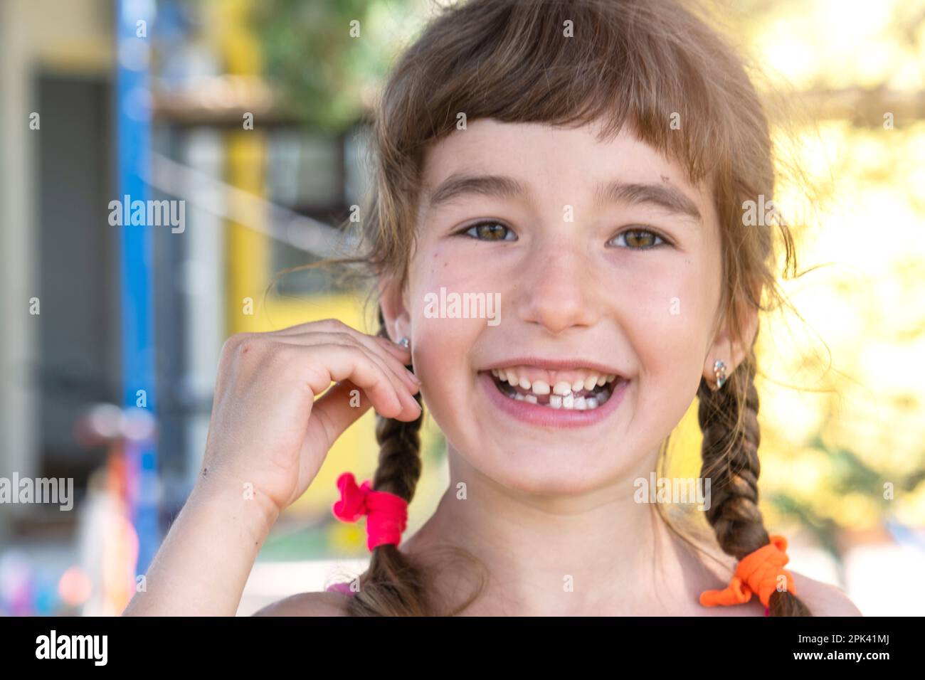 Toothless happy smile of a girl with a fallen lower milk tooth close-up ...