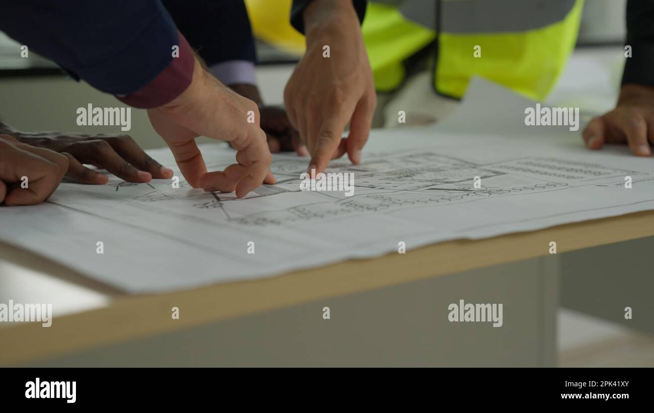 Close up blueprint, male engineer foreman using blueprint assigning ...