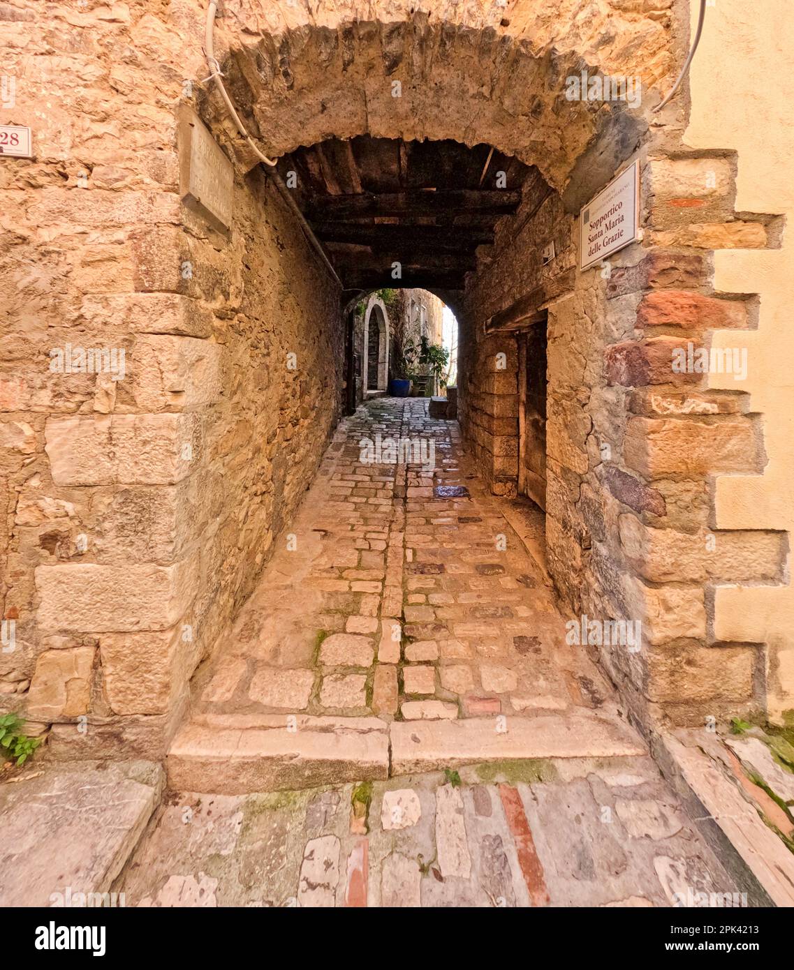 A narrow street among the old houses of Civitacampomarano, a medieval ...