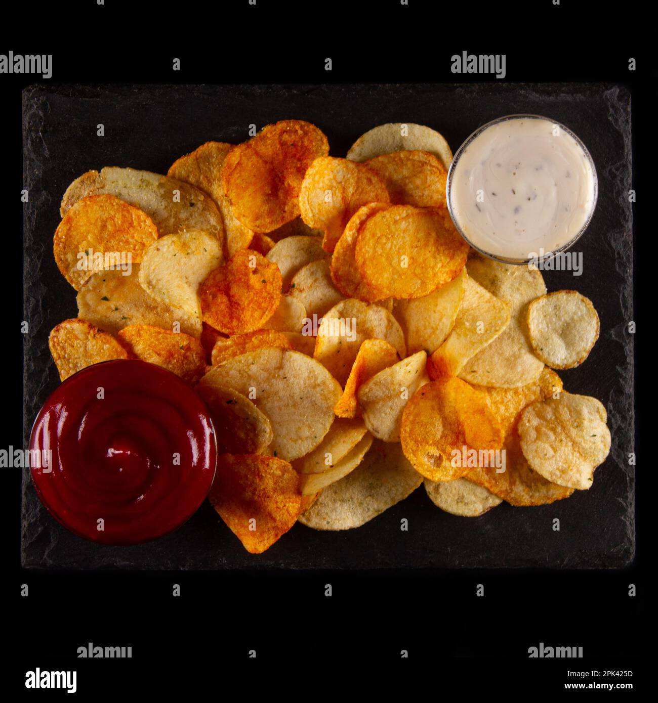 Golden brown and crunchy potato chips with zesty white and savory red ...
