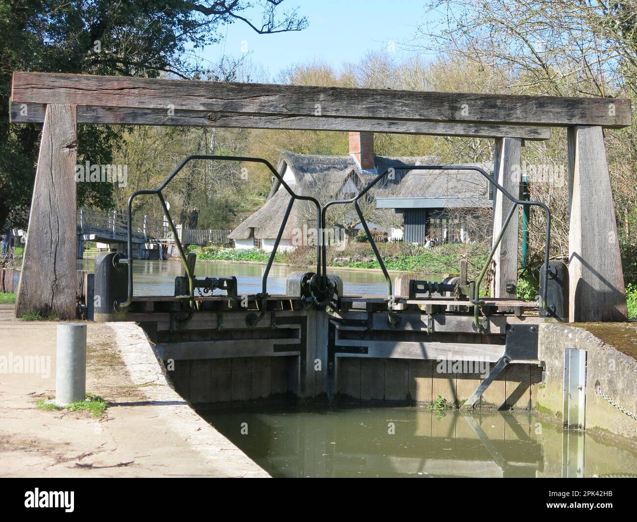 View of Bridge Cottage through the gates at Flatford Lock on the River ...