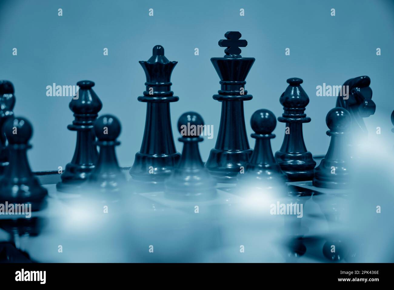 Black chess pieces background white blurred chess pieces standing ...
