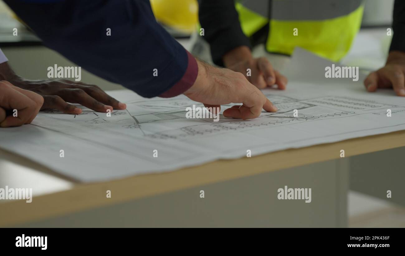 Close up blueprint, male engineer foreman using blueprint assigning ...