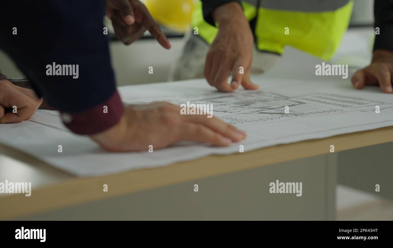 Close up blueprint, male engineer foreman using blueprint assigning ...
