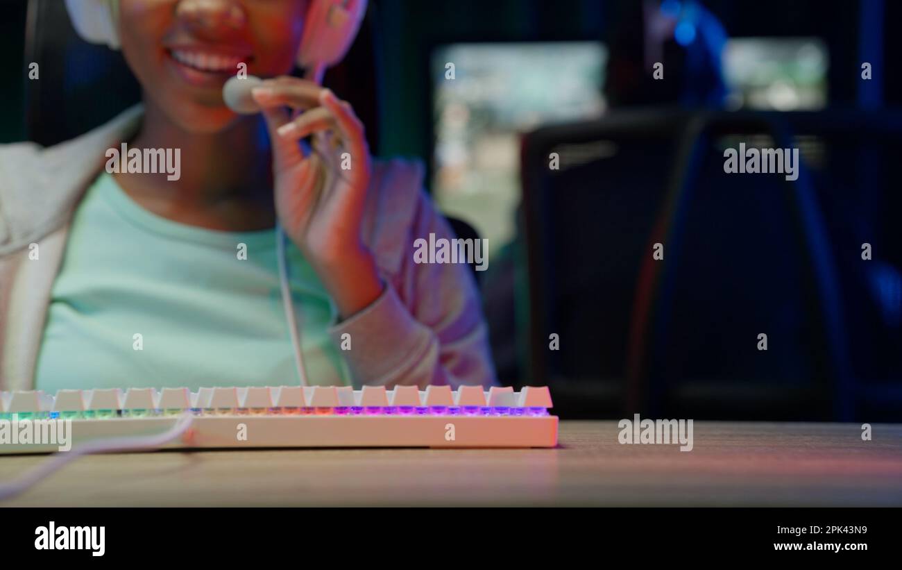 Game streamer using pc setup playing multiplayer first person shooter ...