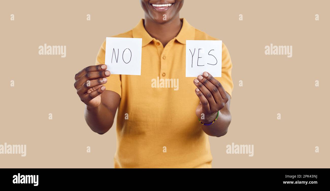Happy African American man choosing between two options and holding YES ...