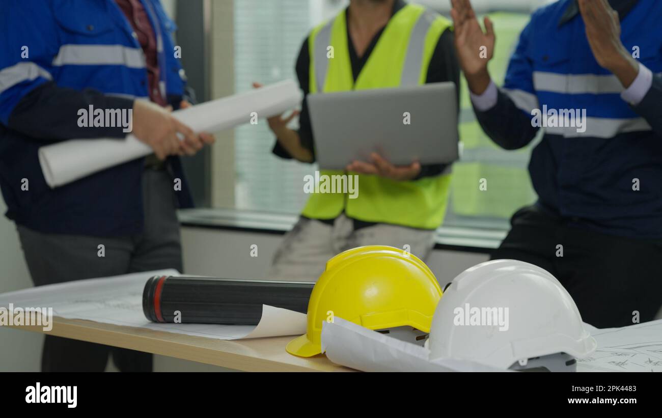 Construction engineers team using blueprint of project plan ...