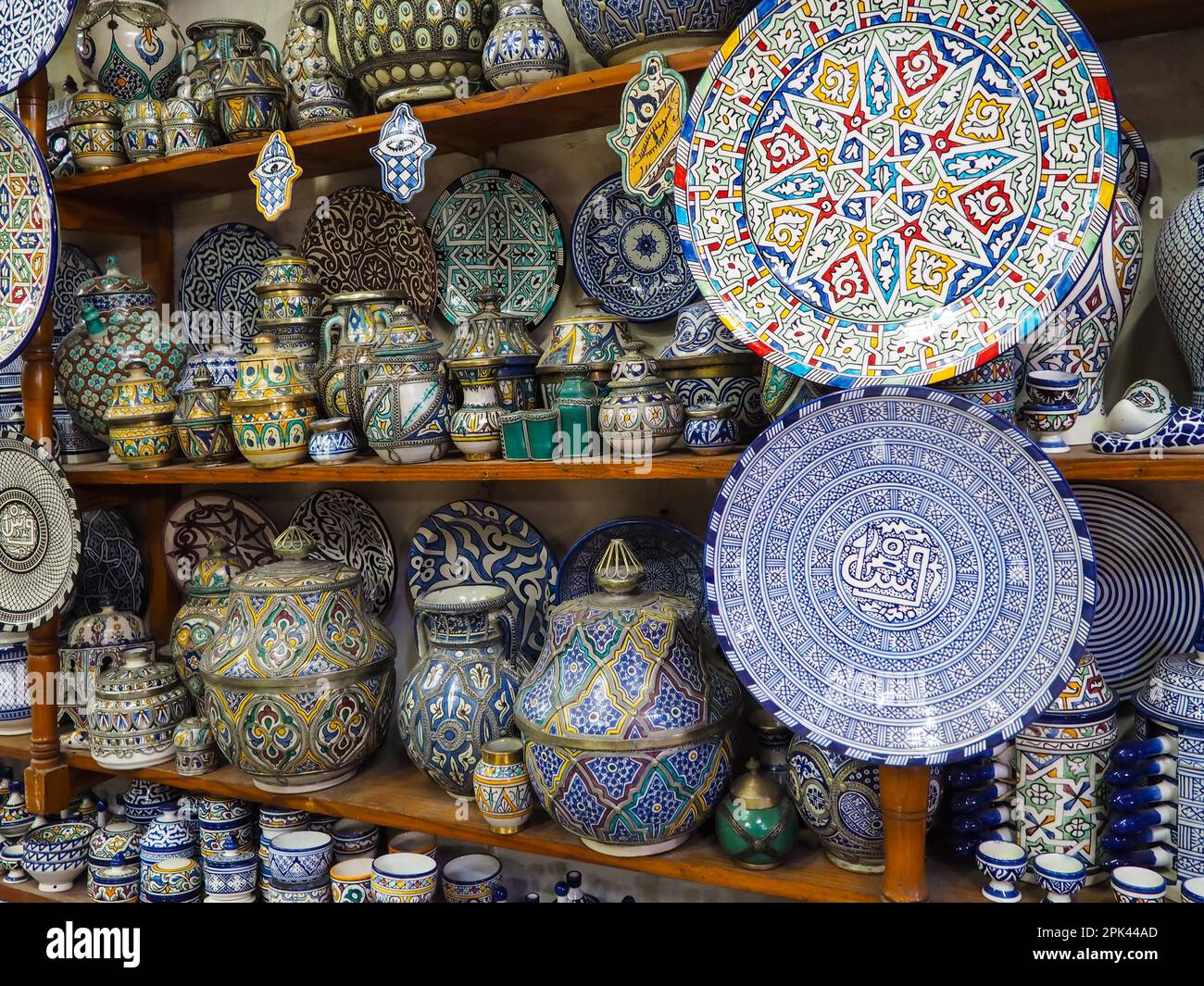 Handmade colourful decorated bowls, plates and cups on display at ...