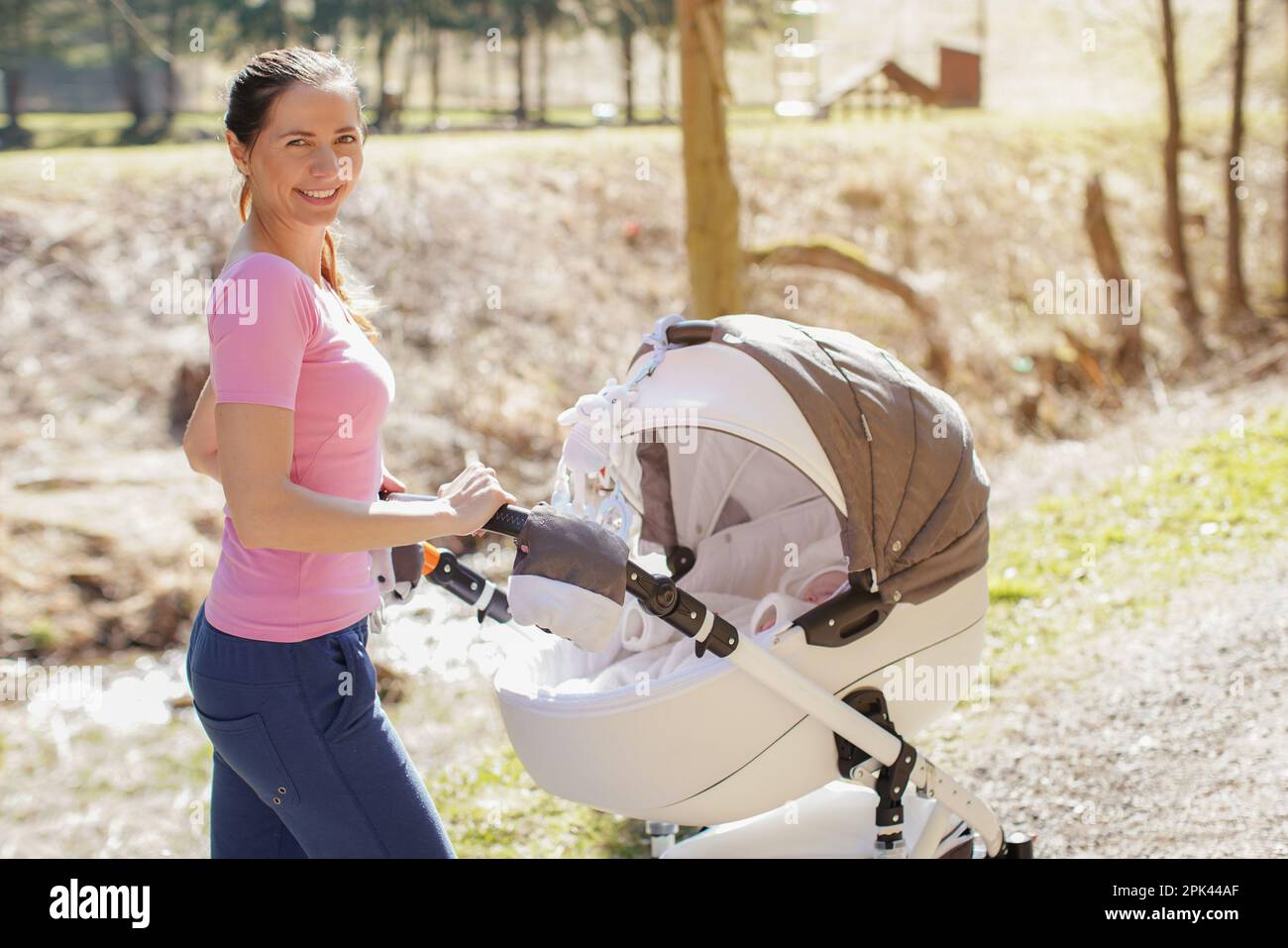 Girl pushing baby carriage hi-res stock photography and images - Alamy