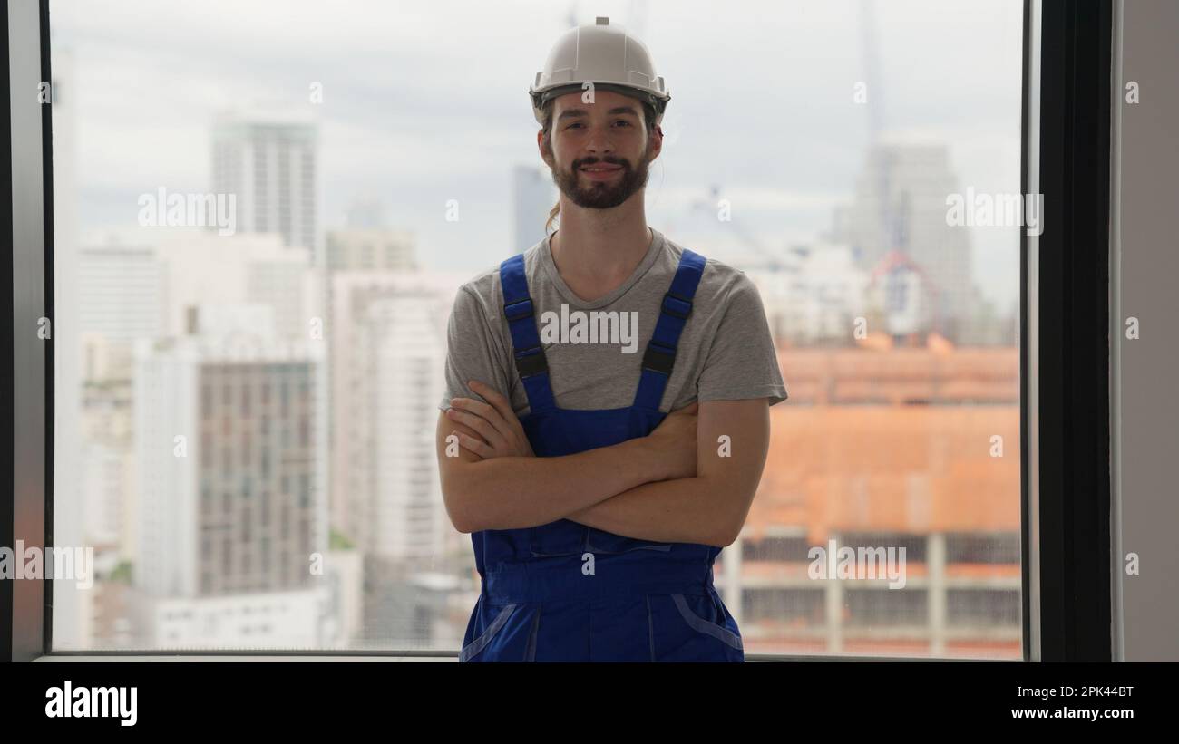 Portrait of confident engineer with safety helmet and vest on building ...