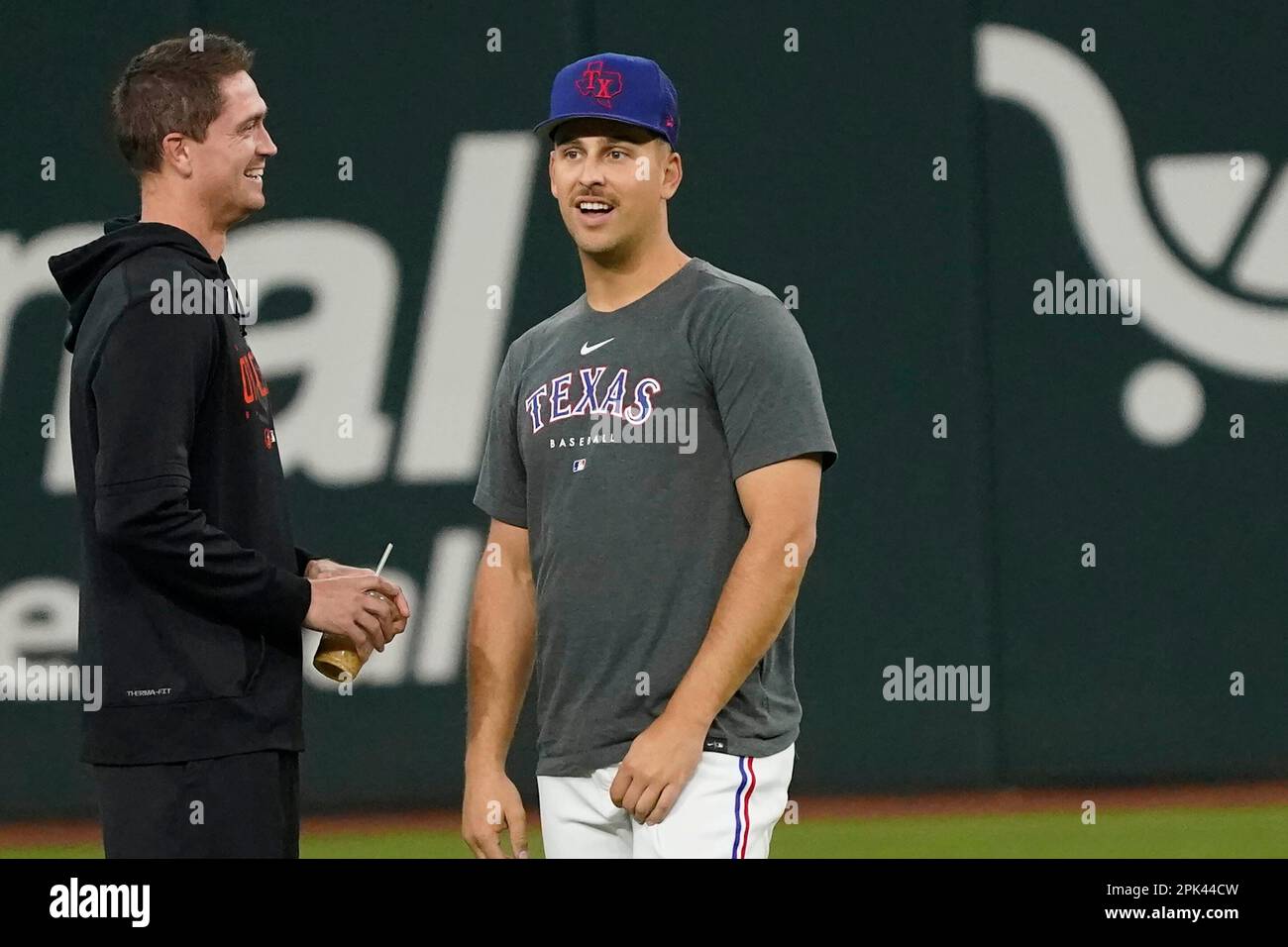 Texas Rangers first baseman Nathaniel Lowe, right, stands on the field during team warm ups ...