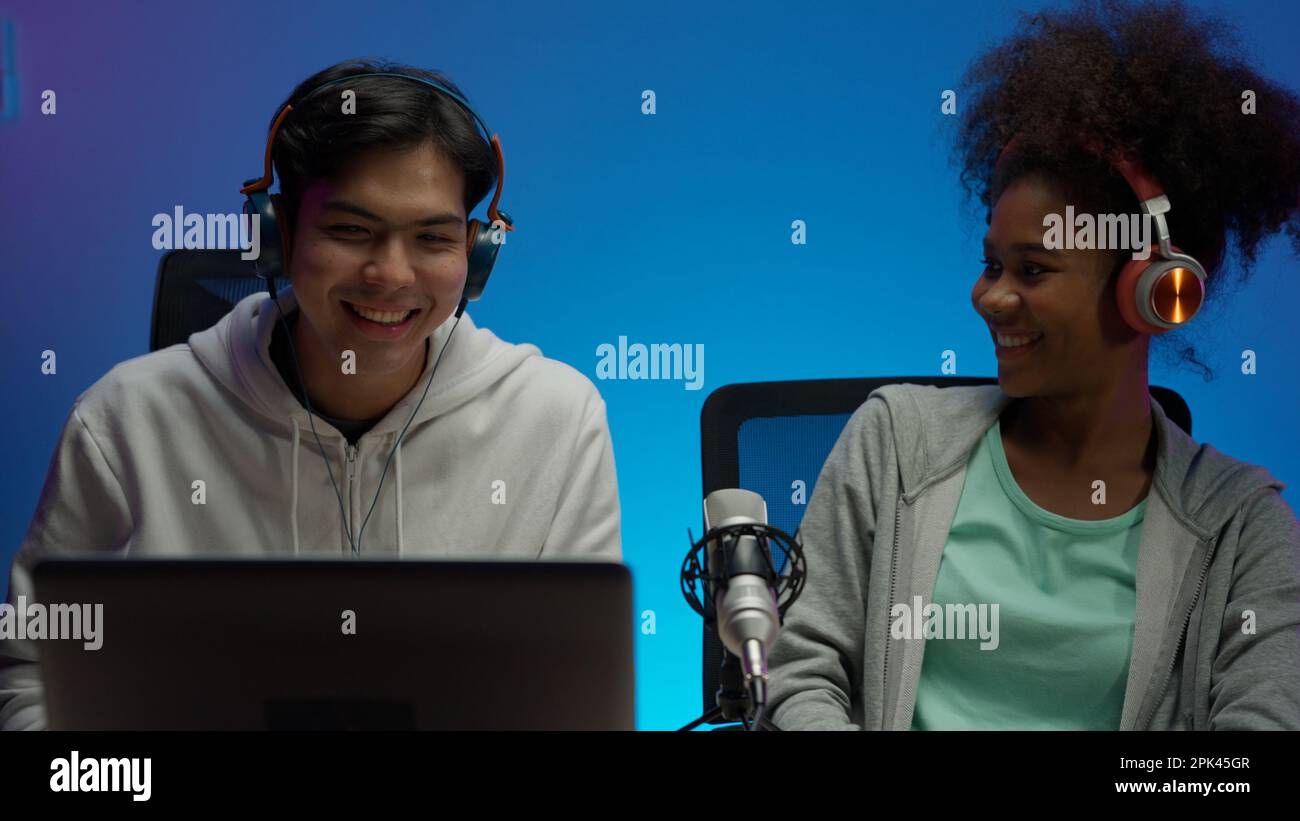 Game streamer using pc setup playing multiplayer first person shooter ...