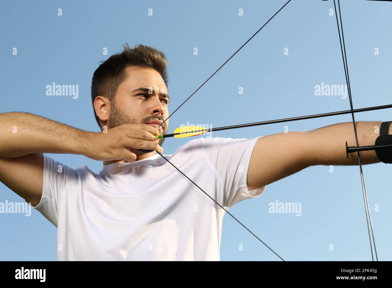 Young man shooting arrow hi-res stock photography and images - Alamy