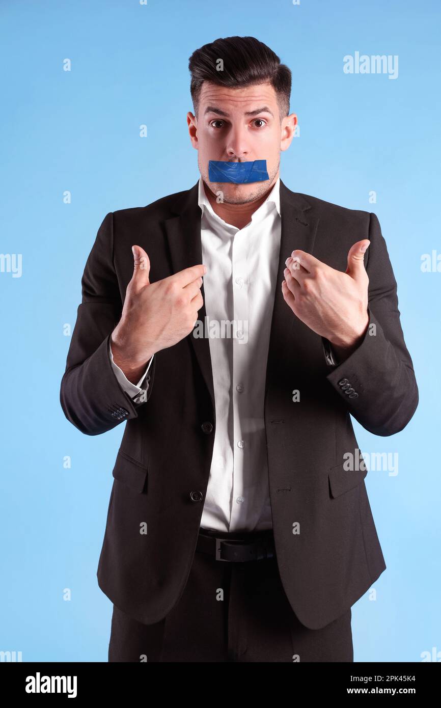 Man with taped mouth on light blue background. Speech censorship Stock ...