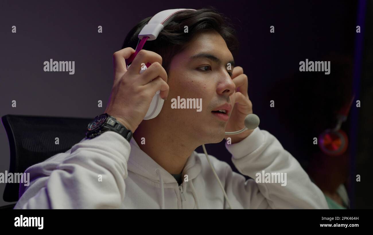 Game streamer using pc setup playing multiplayer first person shooter ...