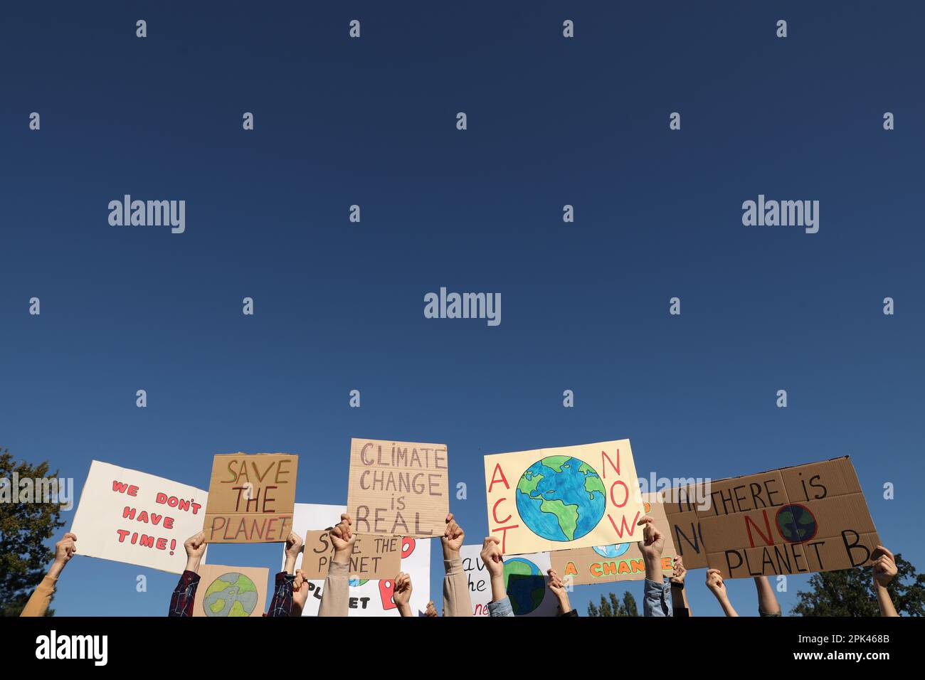 Group of people with posters protesting against climate change outdoors ...