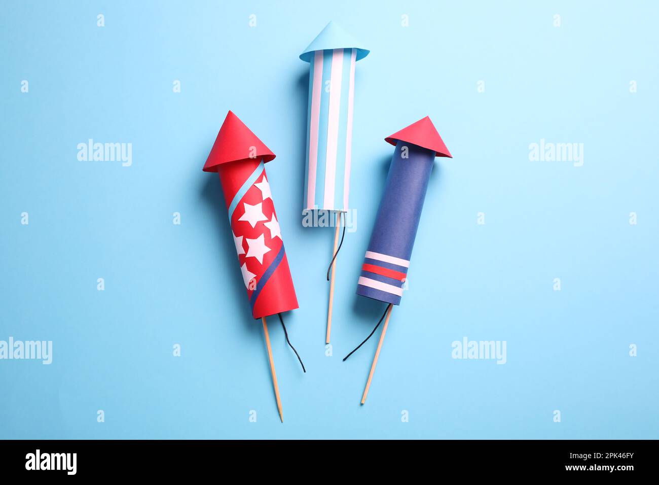 Firework rockets on light blue background, flat lay Stock Photo - Alamy