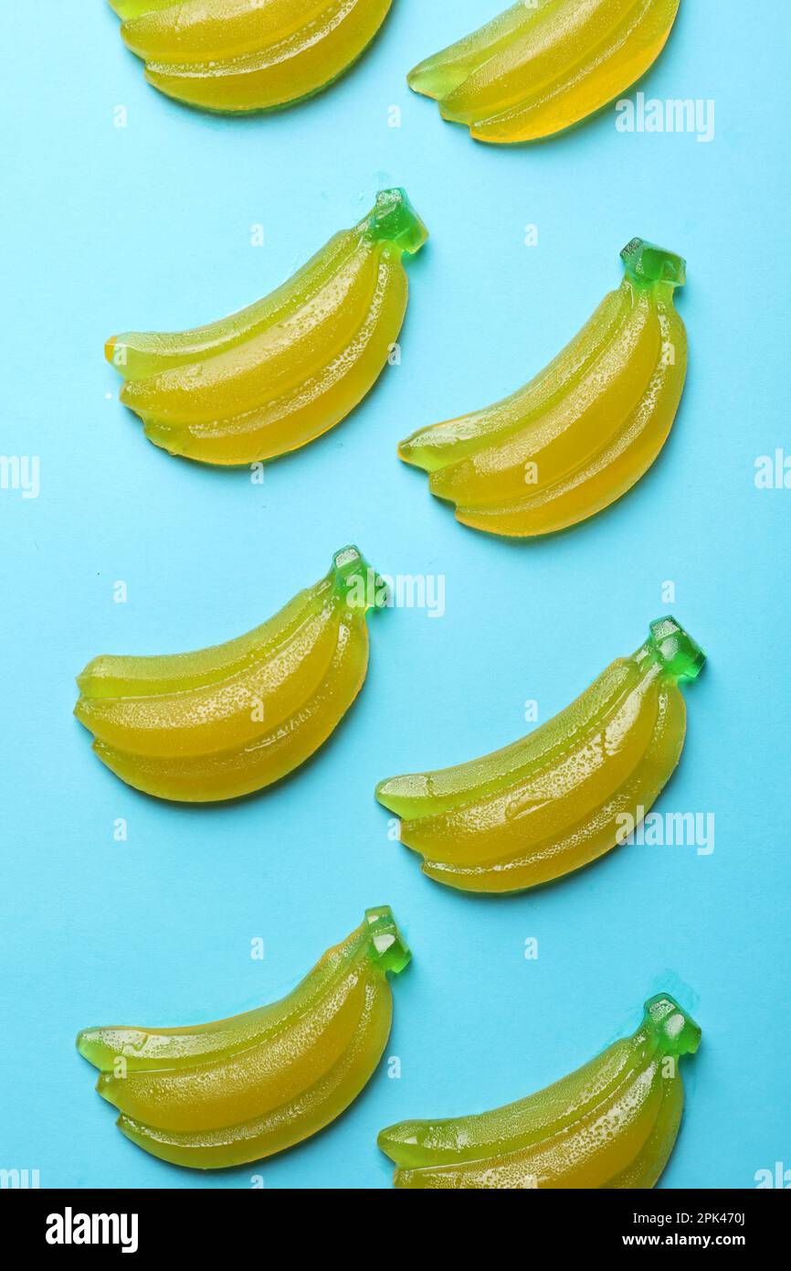 Delicious gummy banana candies on light blue background, flat lay Stock ...