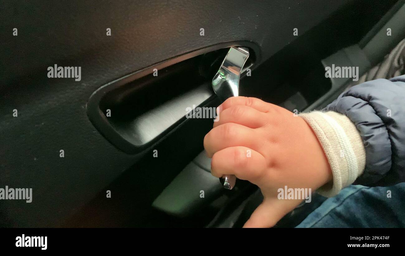 Baby unable to open car door handle because of child lock Stock Photo ...