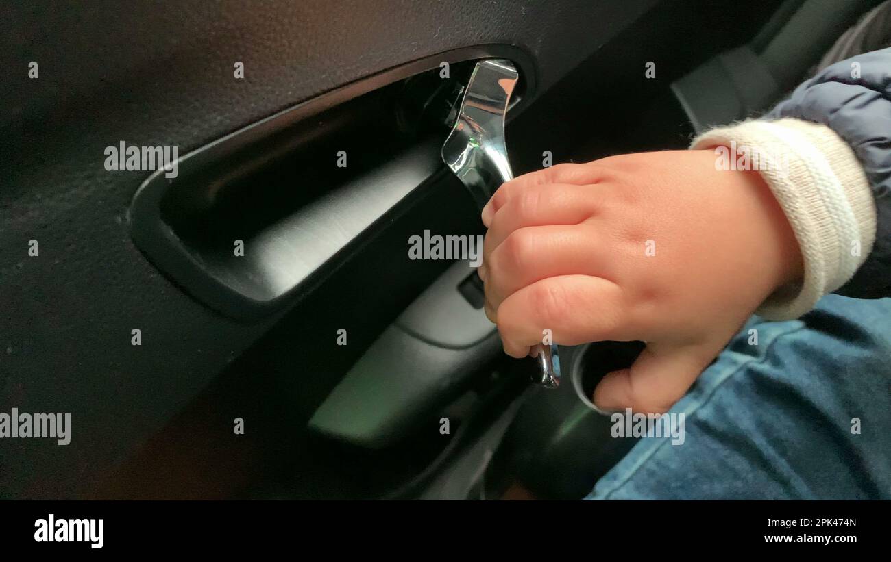 Baby unable to open car door handle because of child lock Stock Photo ... Baby unable to open car door handle because of child lock Stock Photo ...