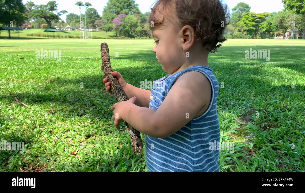 Baby toddler walking outside on lawn barefoot, infant falling down ...