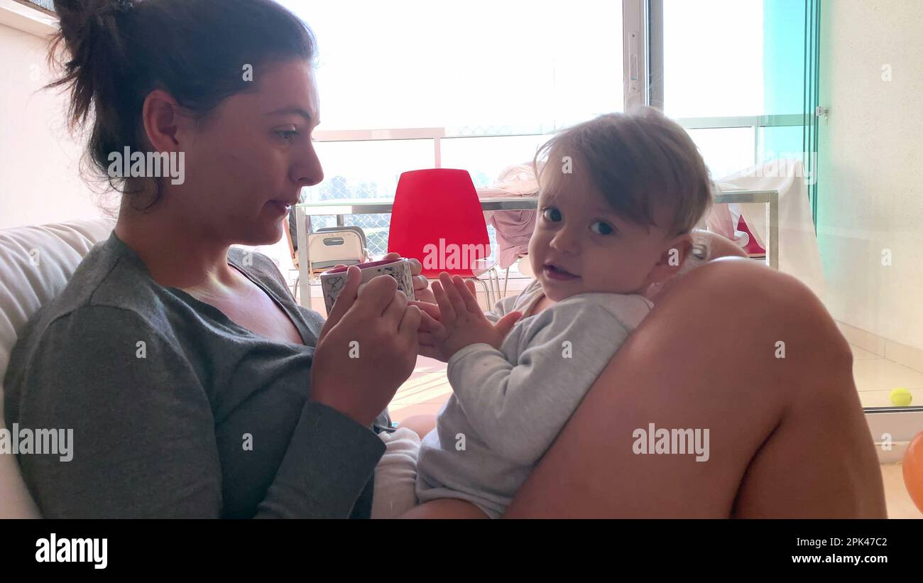 Candid mother and baby together at home, authentic real life parent and child interaction Stock ...