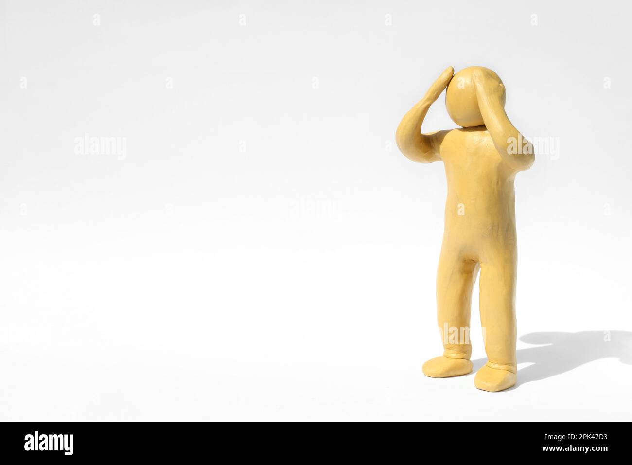 Plasticine figure of troubled human on white background. Space for text ...