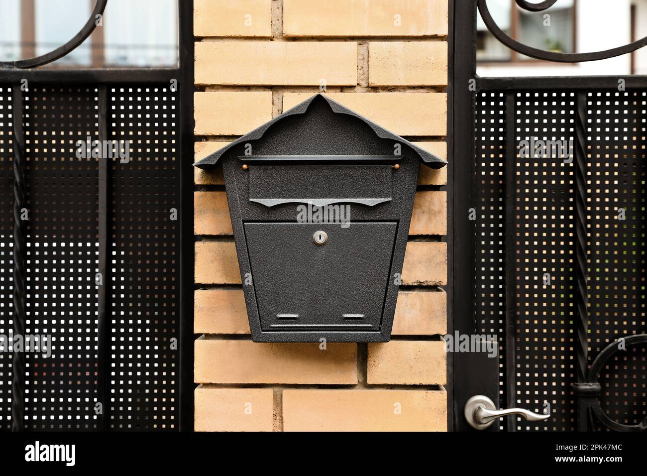 Vintage letter box on beige brick wall near door outdoors Stock Photo ...