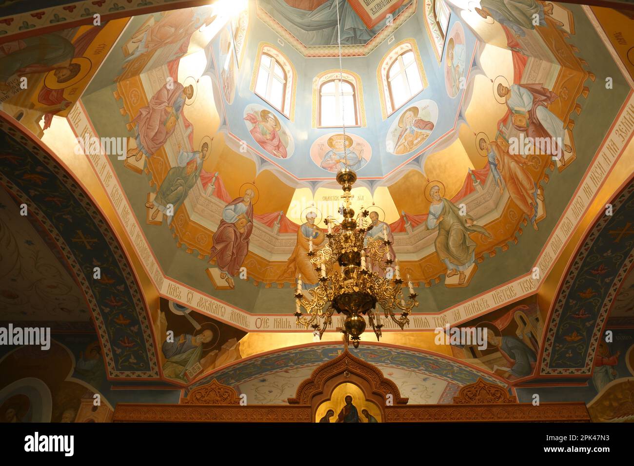 Beautiful church interior with chandelier and dome vault, low angle ...