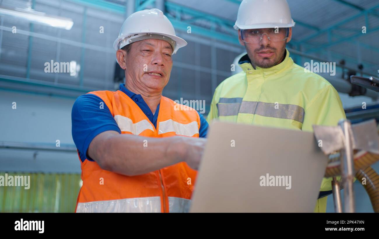 Engineer specialist checking and controlling machine in industrial ...