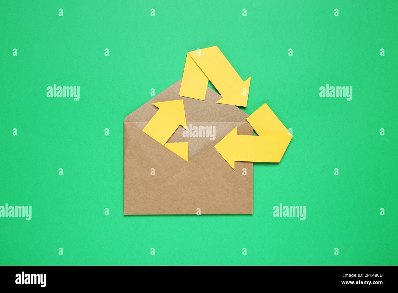 Open envelope and recycling symbol on green background, top view Stock ...